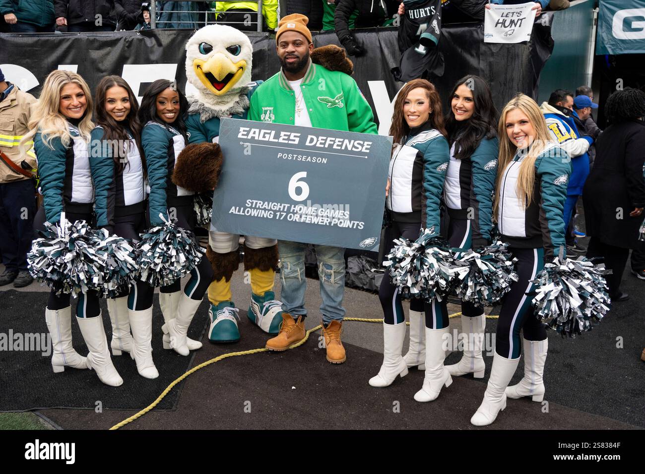 Former Philadelphia Eagles Fletcher Cox poses with a sign along with ...