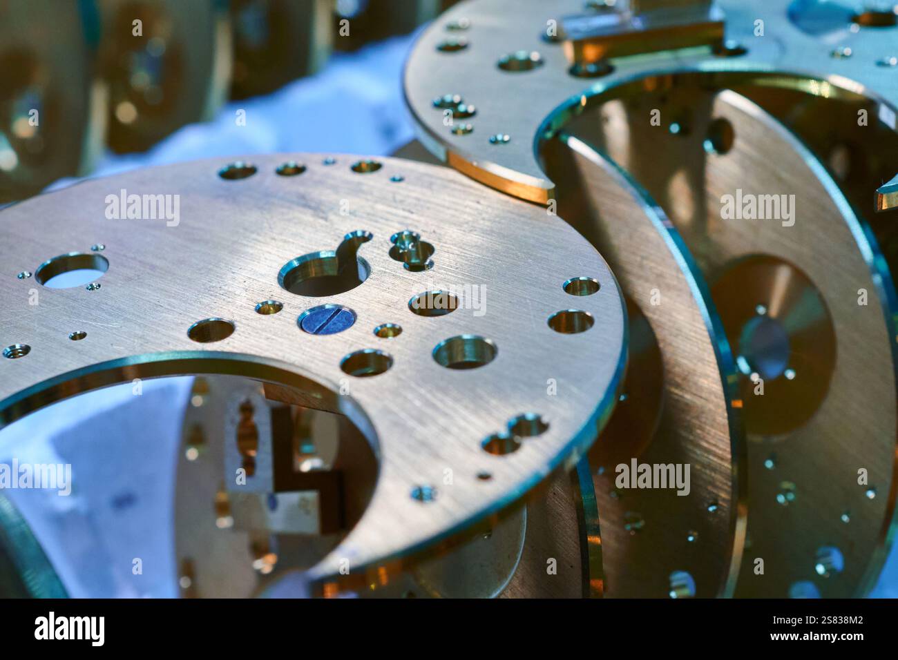 Intricate watch mechanism bases crafted from metal waiting for assembly ...