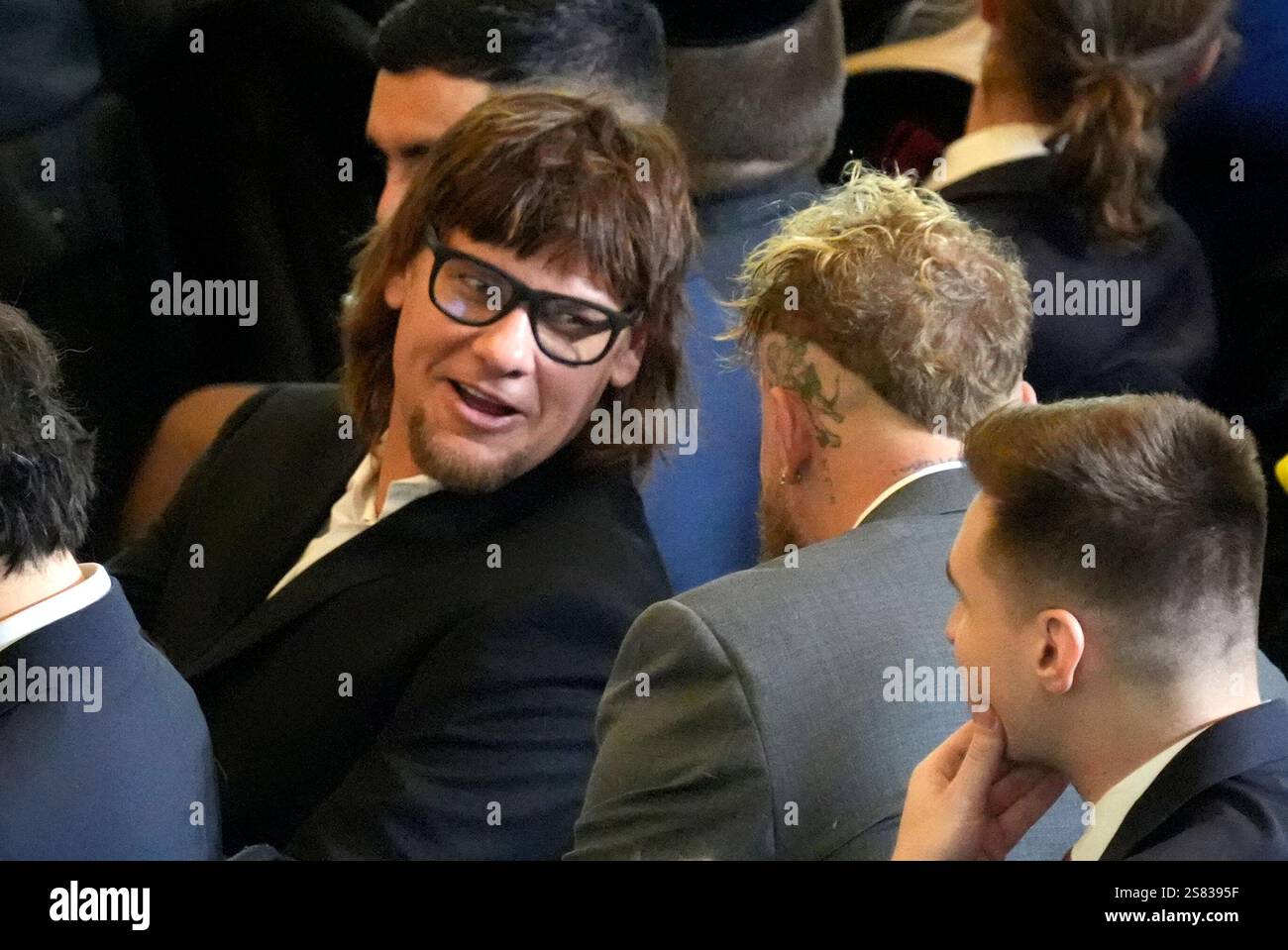 Comedian Theo Von, left speaks with Jake Paul in the viewing area in ...