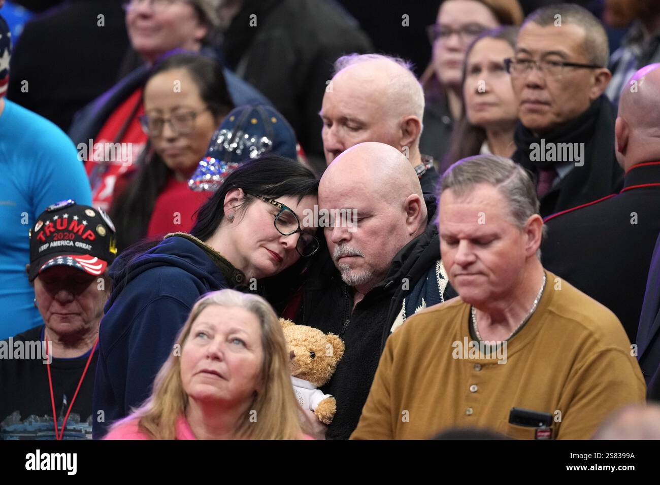 Attendees pray at an indoor Presidential Inauguration parade event in ...