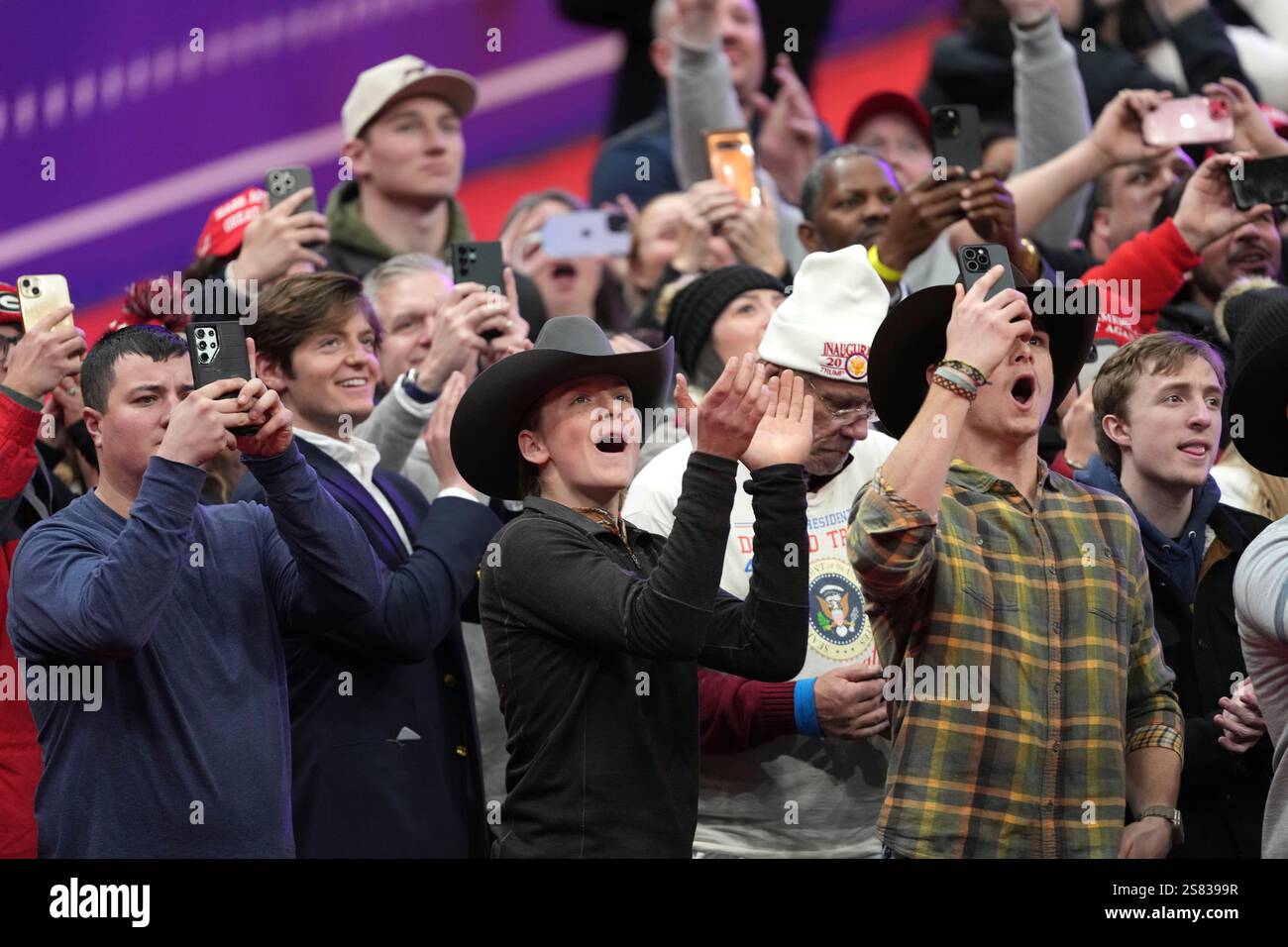 Attendees cheer at an indoor Presidential Inauguration parade event in ...