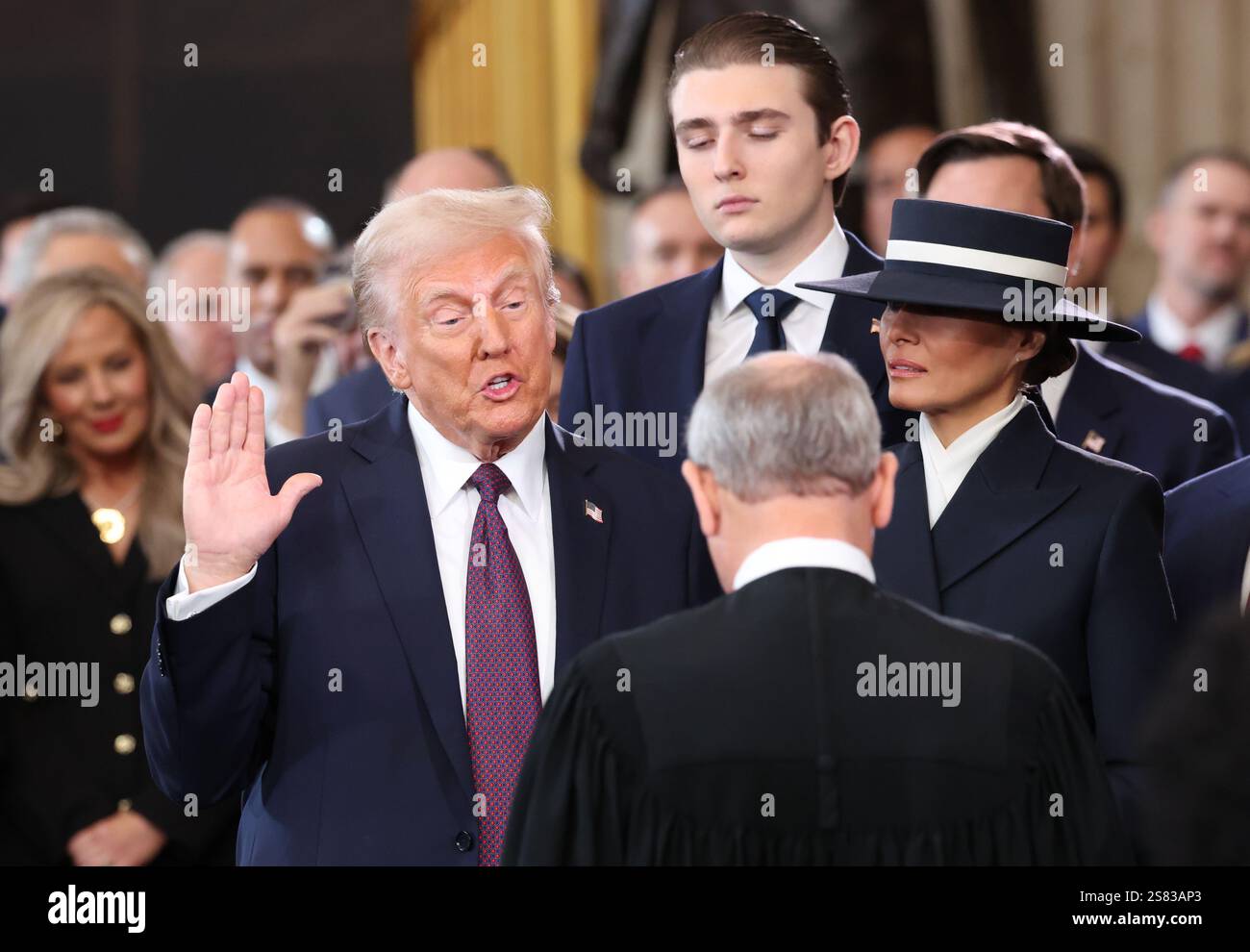 U.S. President Donald Trump takes oath as Barron Trump and Melania ...