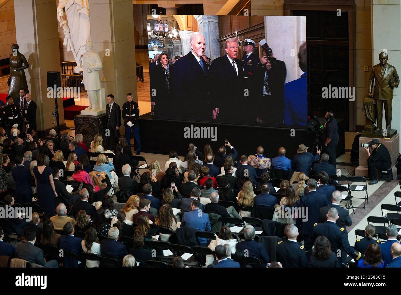 Attendees watch a livestream in Emancipation Hall showing President Joe ...