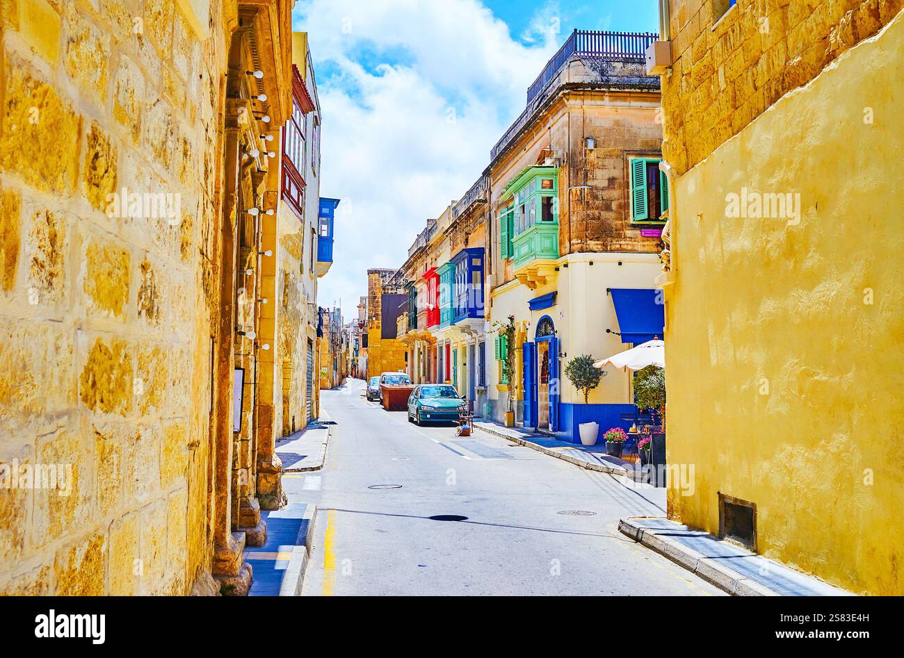 The line of scenic historic residential houses with wooden Maltese ...