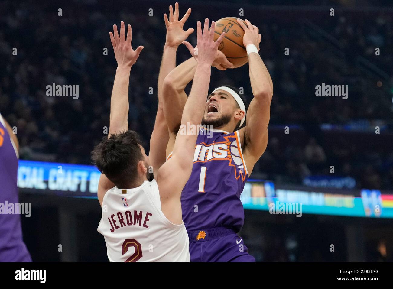 Phoenix Suns guard Devin Booker (1) shoots as Cleveland Cavaliers guard ...