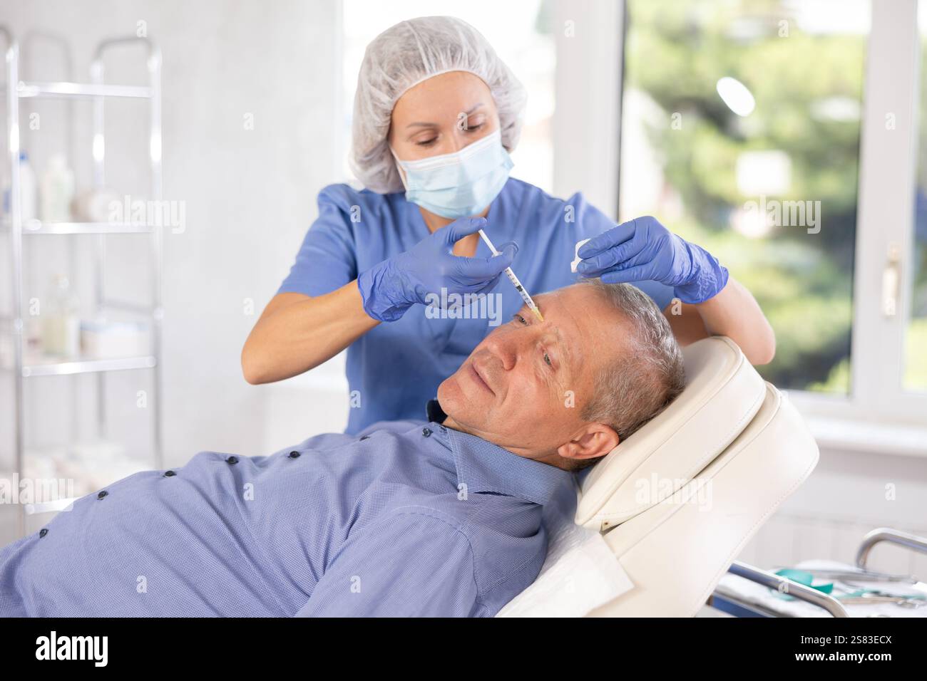 Doctor performs procedure of injectable correction of wrinkles in nasal ...
