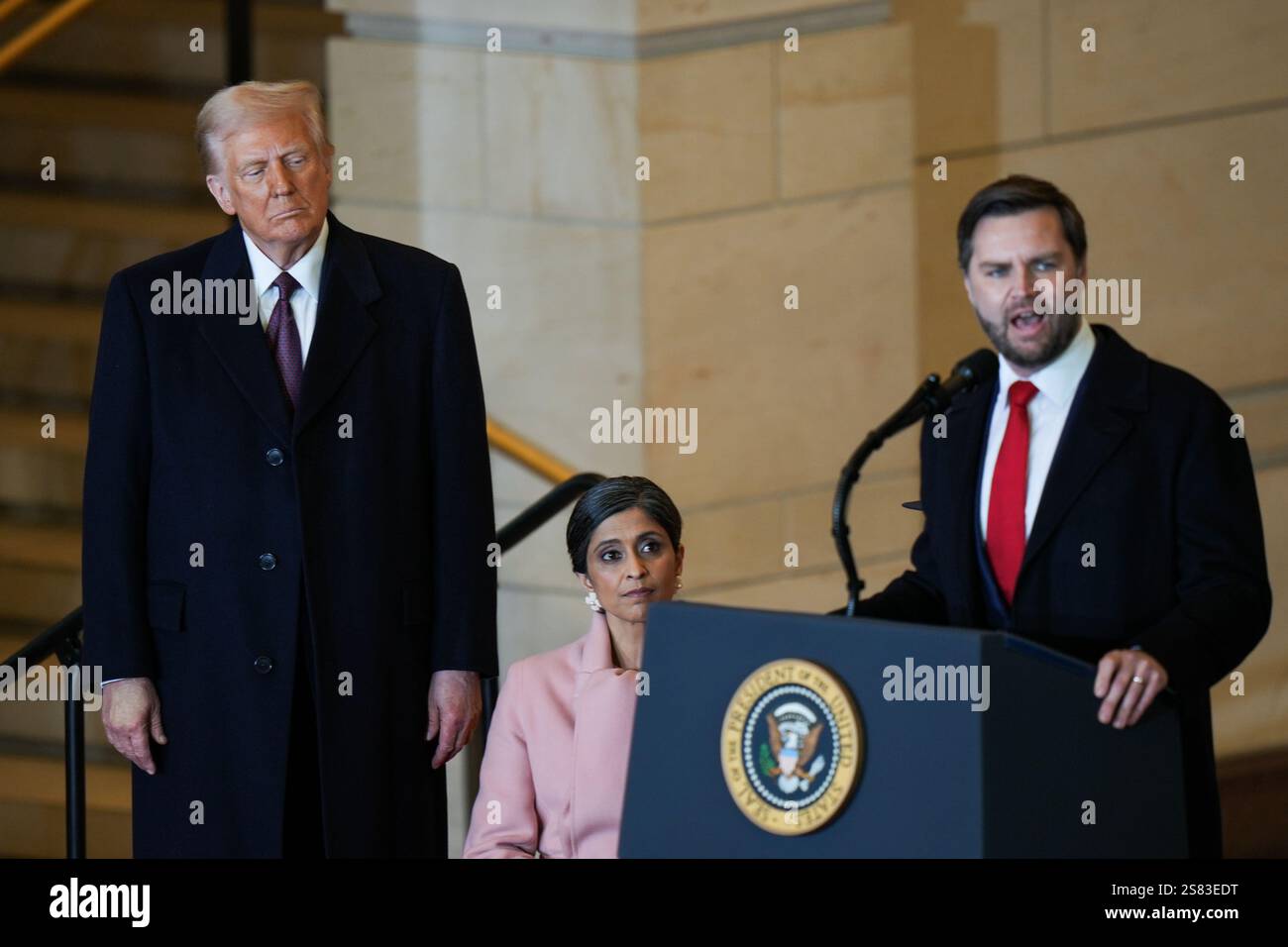 President Donald Trump listens as Vice President JD Vance delivers ...