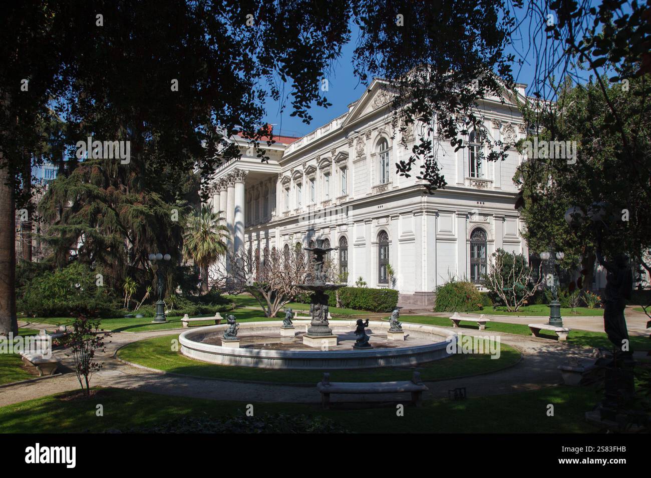 A fountain at the garden and the classic facade of the Former National ...