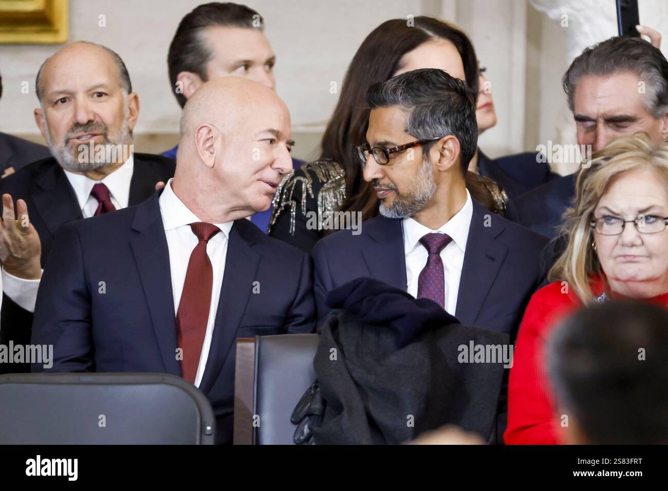 Businessman Jeff Bezos (L) talks with Alphabet’s CEO Sundar Pichai (R ...