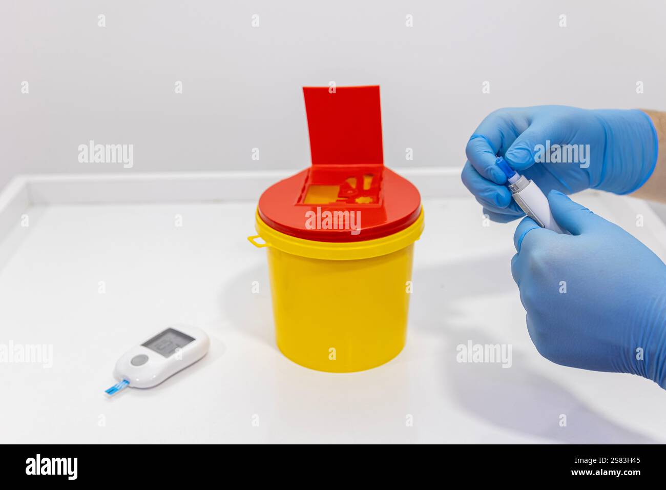 Old medicine syringes thrown into a medical waste container. The ...