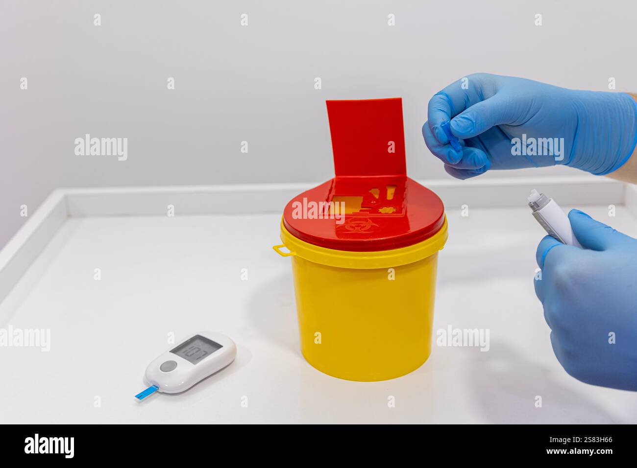 Old medicine syringes thrown into a medical waste container. The ...