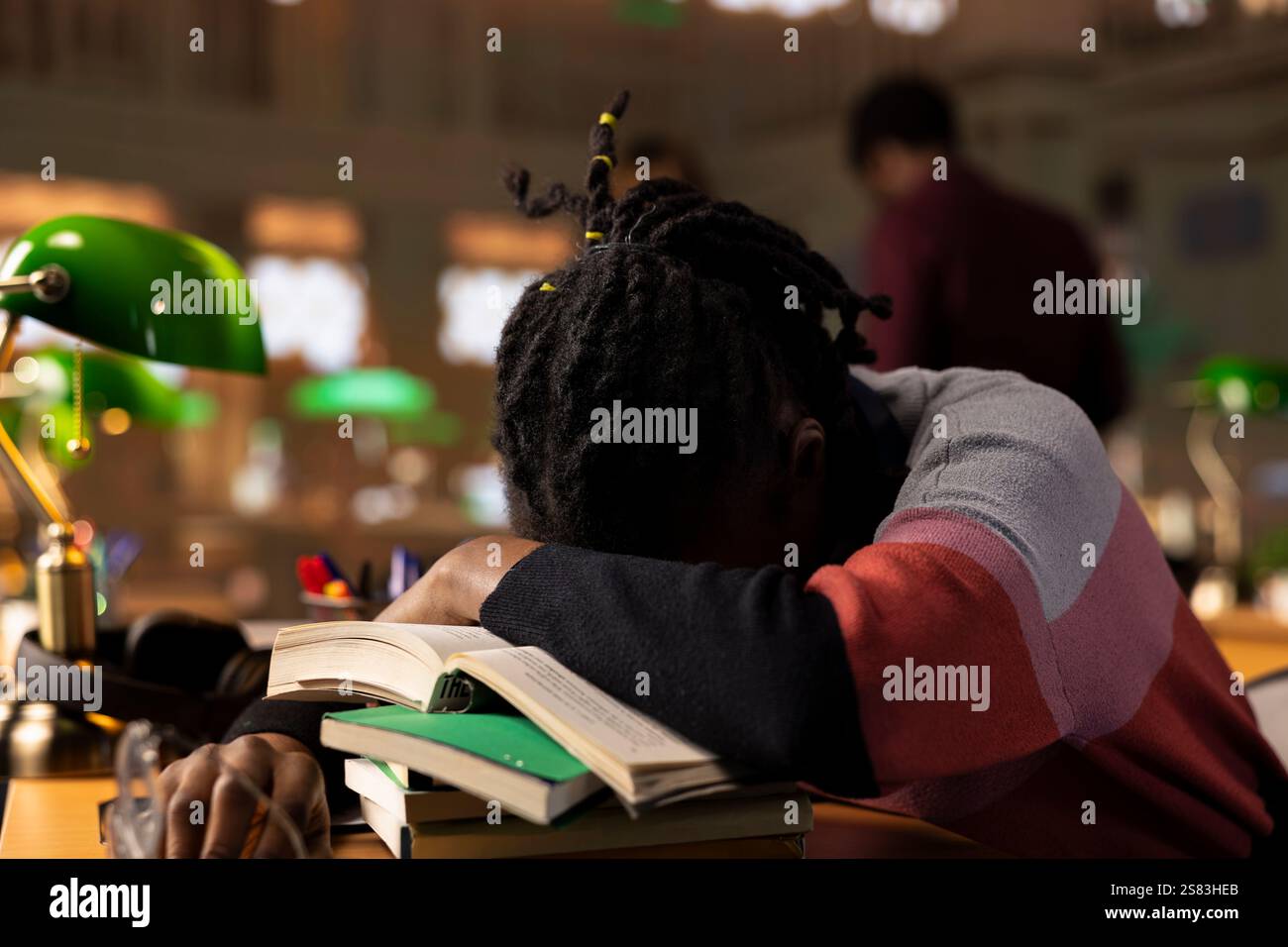 African american girl sleeping on books stack after a long night of ...