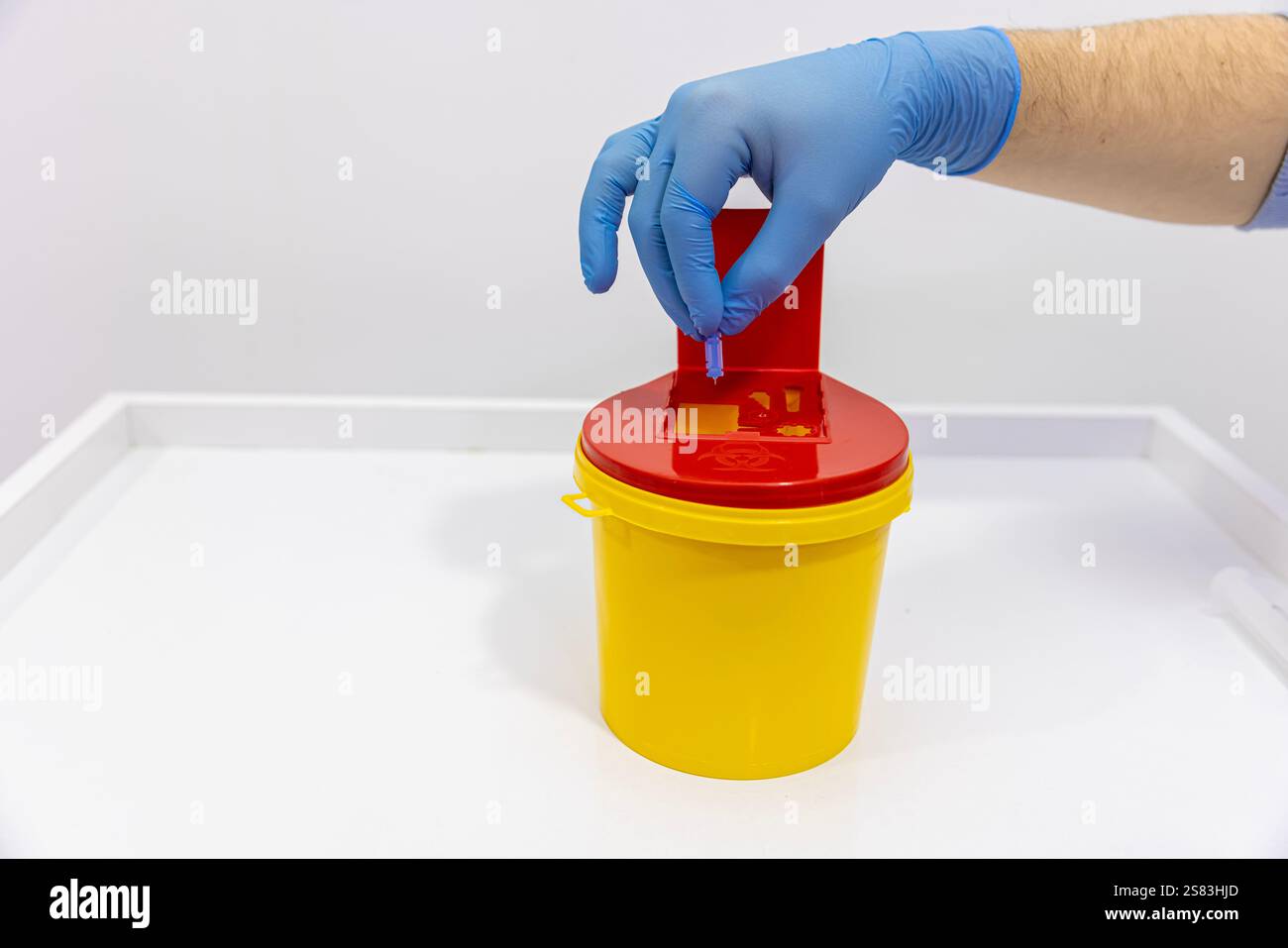 Old medicine syringes thrown into a medical waste container. The ...