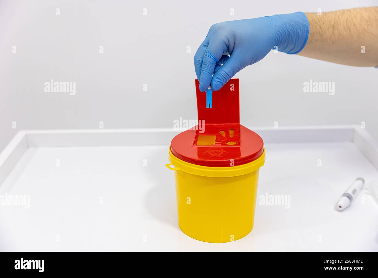 Old medicine syringes thrown into a medical waste container. The ...