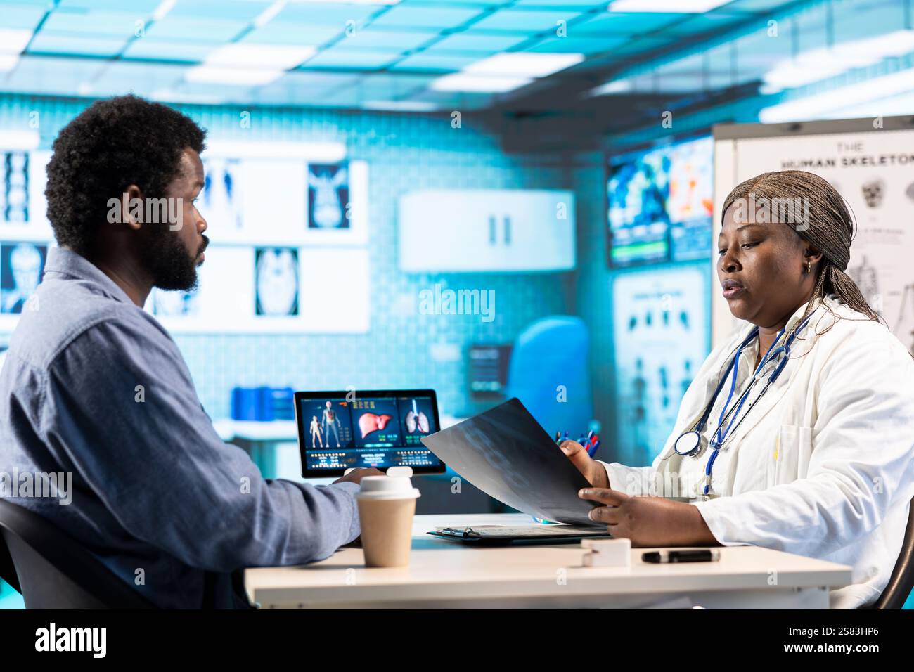 Medical interaction between a doctor and male patient with spinal pain ...