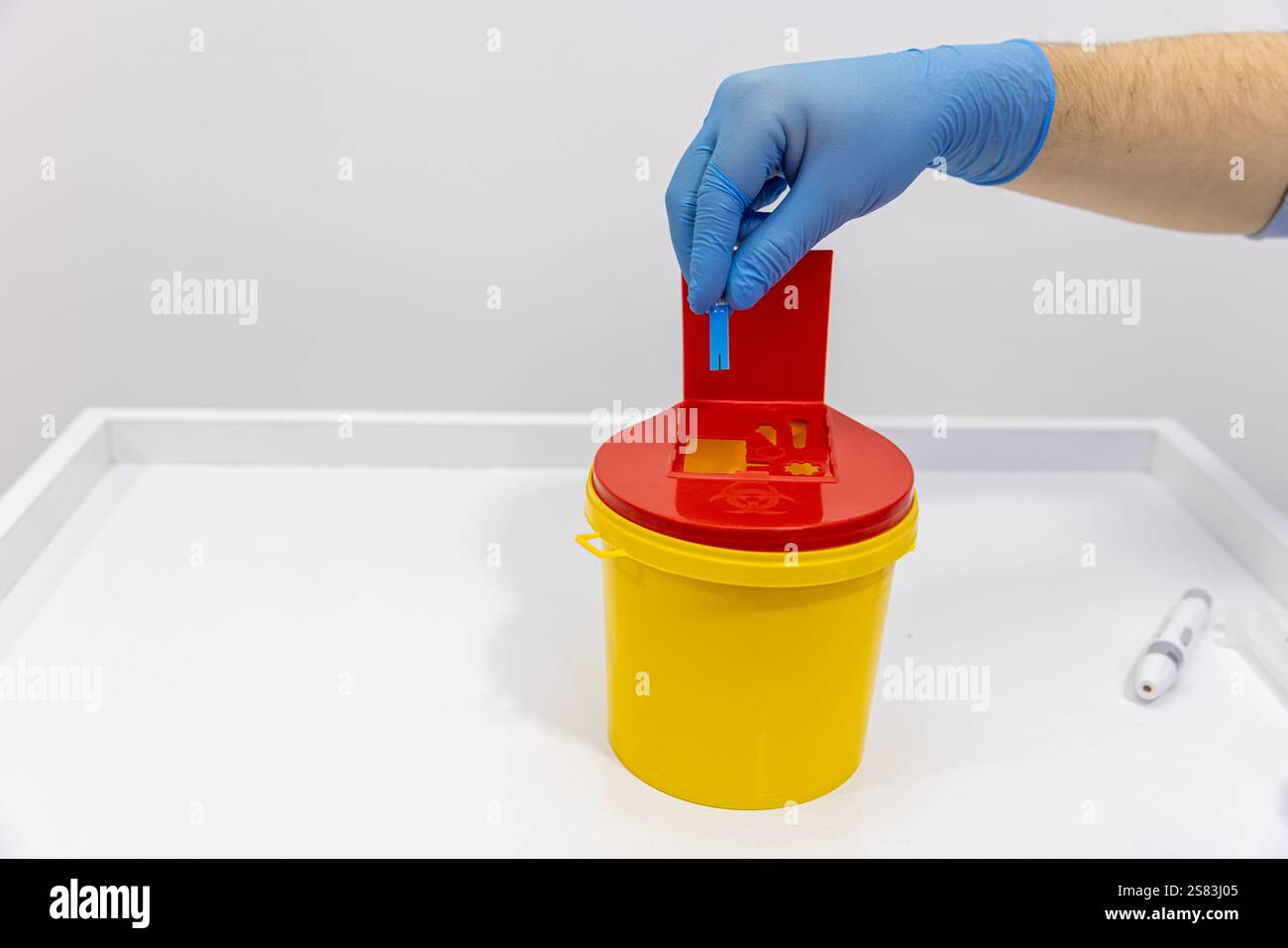 Old medicine syringes thrown into a medical waste container. The ...