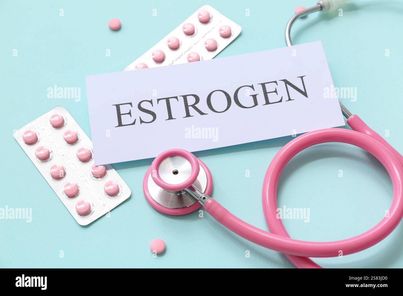 Word ESTROGEN with stethoscope and blisters of hormonal pills on ...