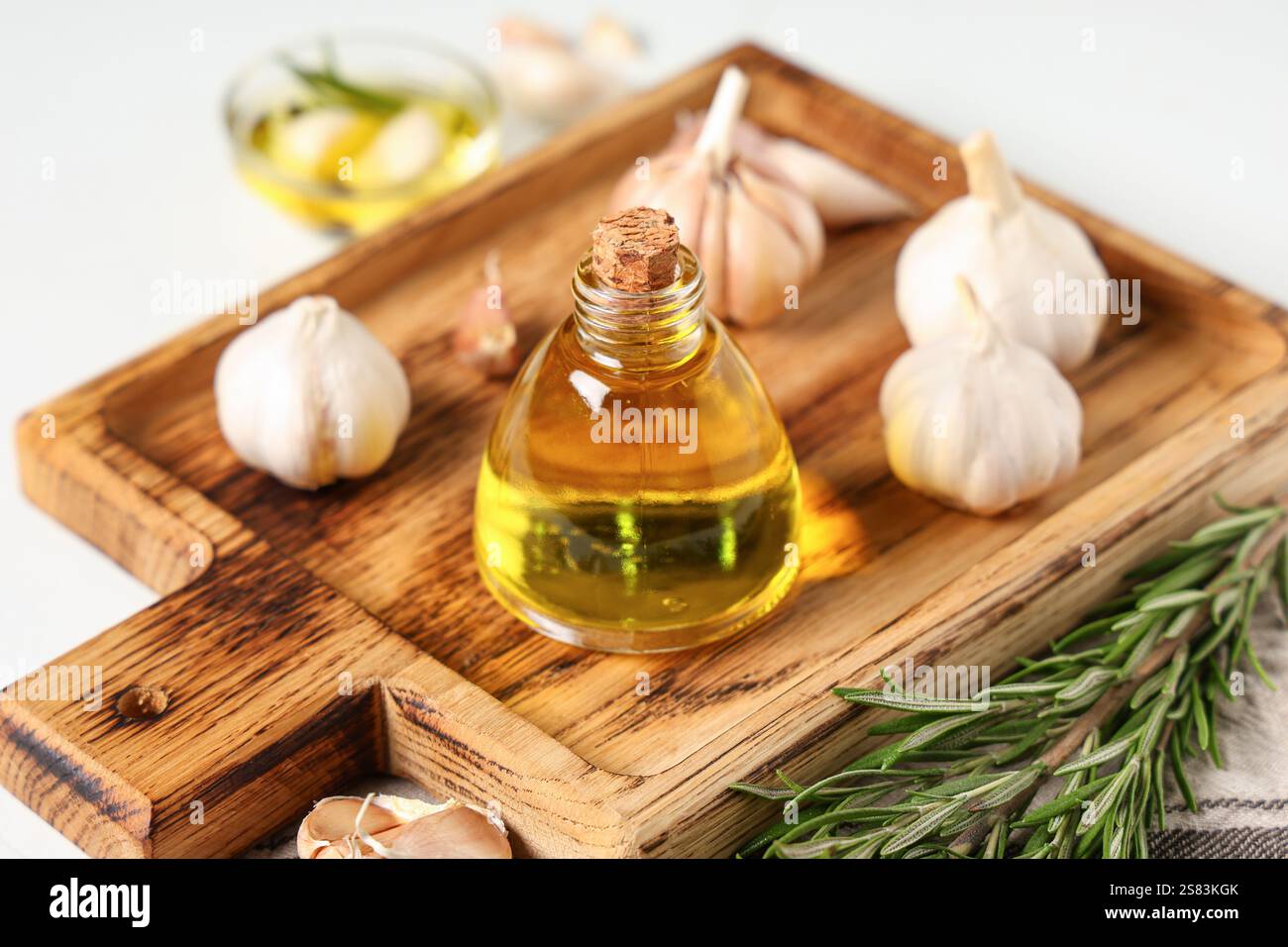 Bottle of fresh garlic oil with rosemary on white background Stock ...