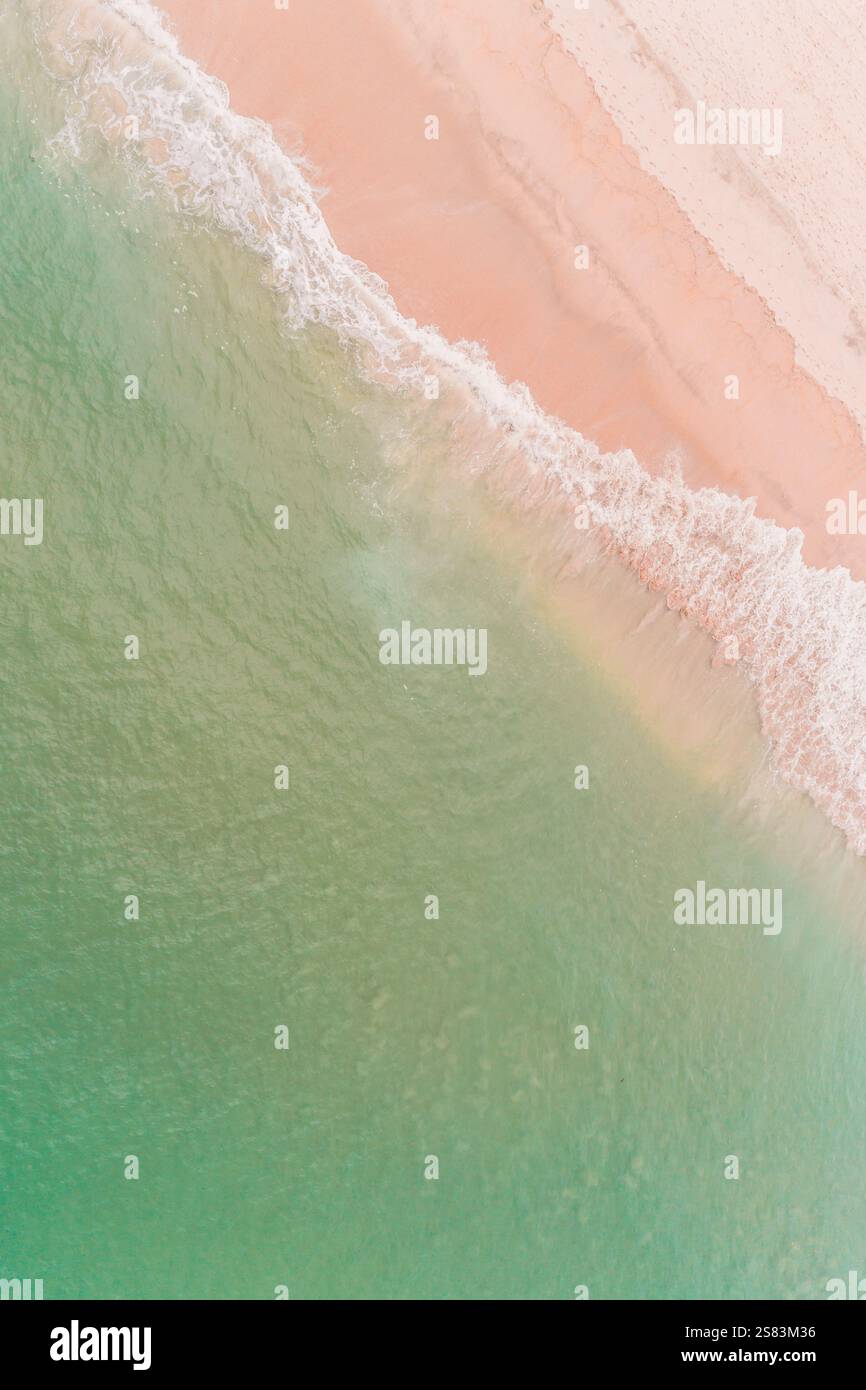 shore of a beach with turquoise water seen from a zenith aerial view ...