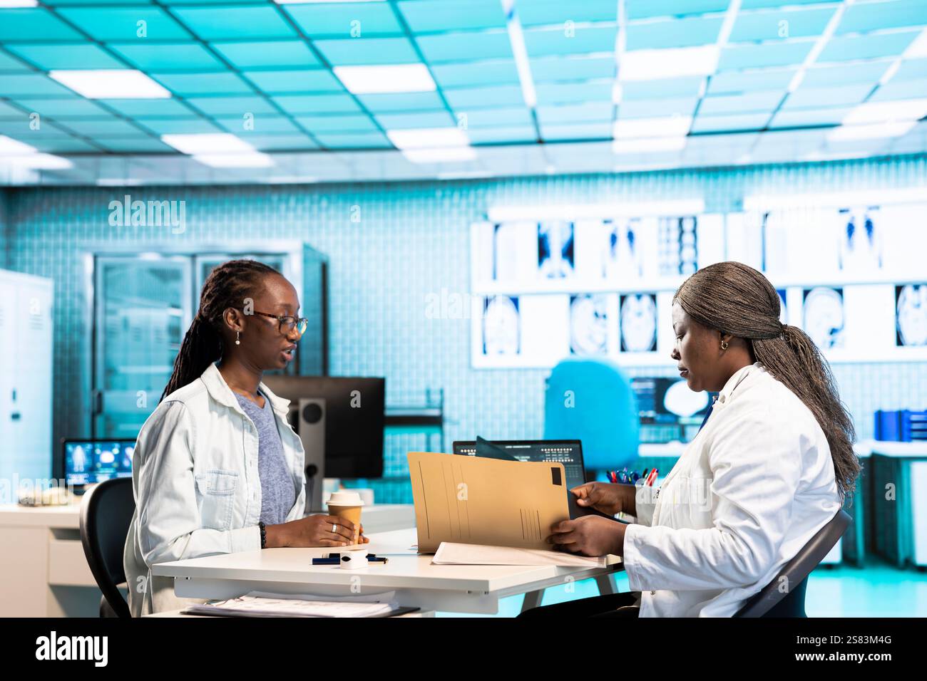 African american woman doctor explaining radiology results to a girl ...