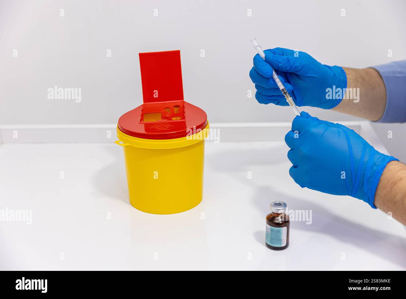 Old medicine syringes thrown into a medical waste container. The ...