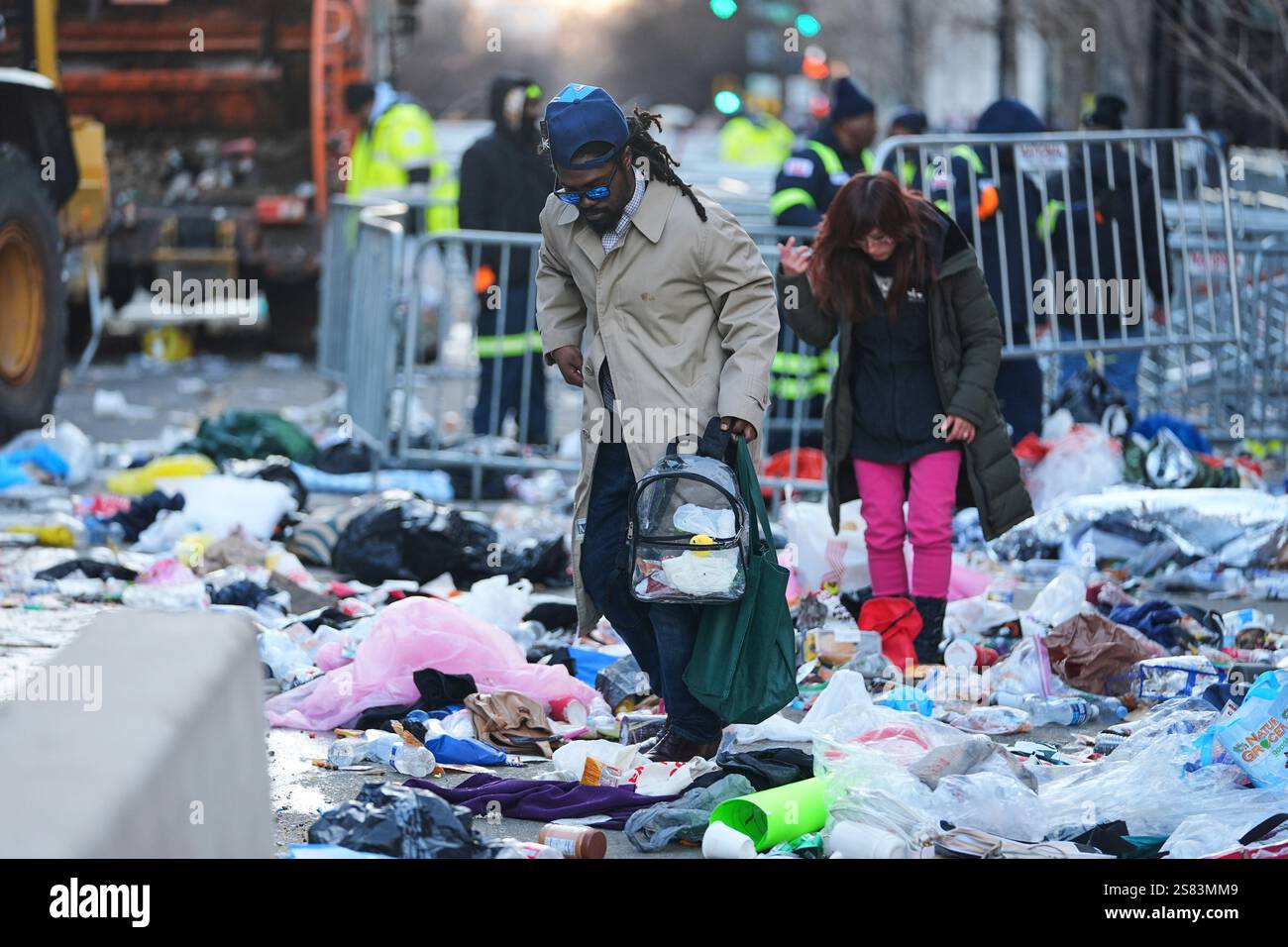 A man looks among a pile of discarded bags and garbage left behind by ...