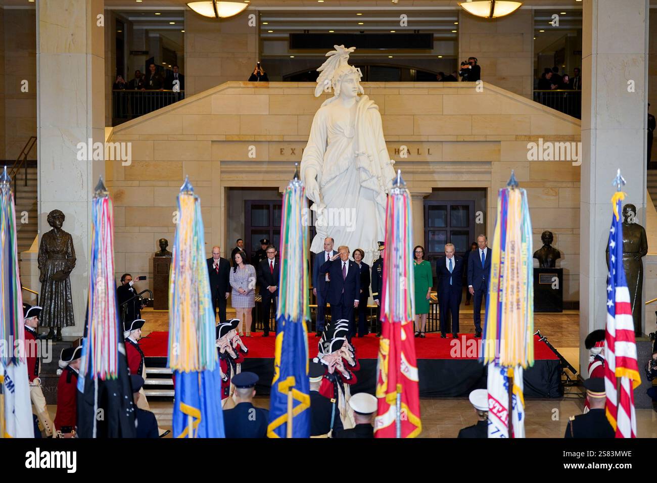US President Donald Trump, center, salutes while inspecting the troops ...