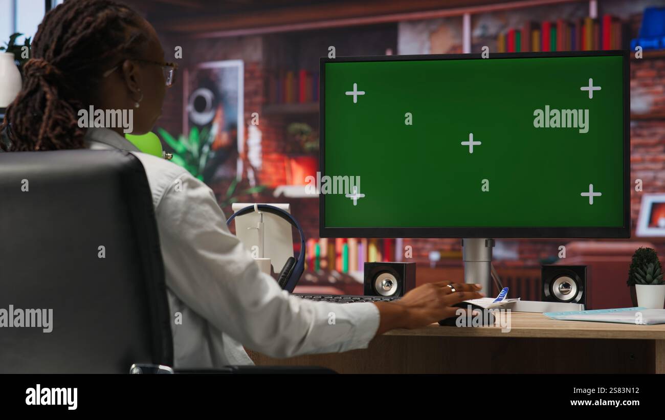 Teleworker using green screen PC in home office to write emails. Remote ...