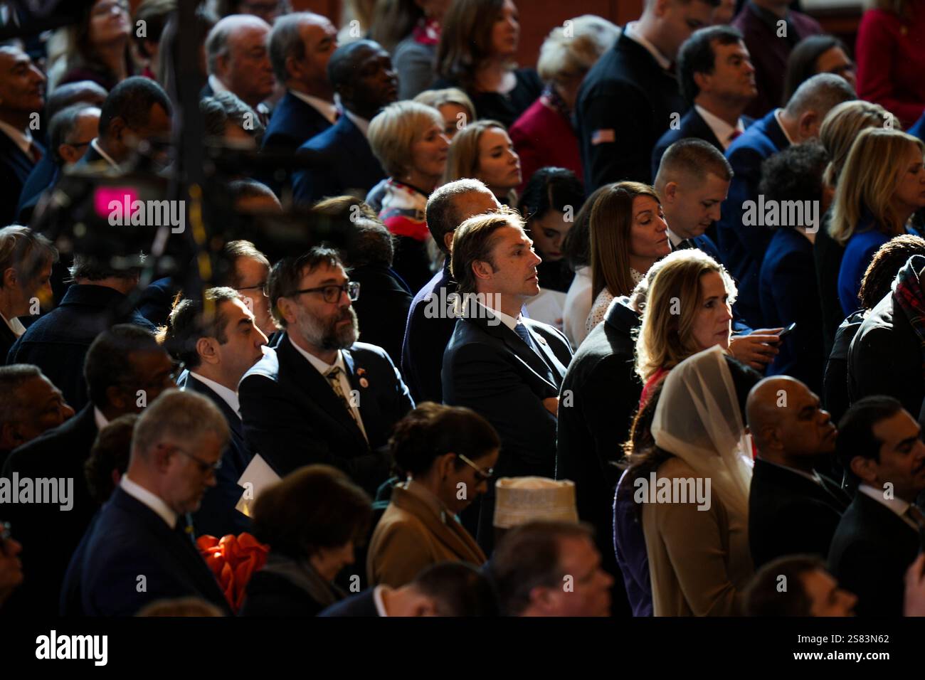 Attendees listen as President Donald Trump delivers remarks in ...