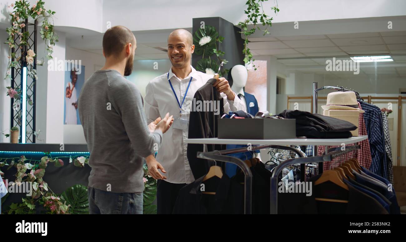 Employee presenting clothes customer hi-res stock photography and ...