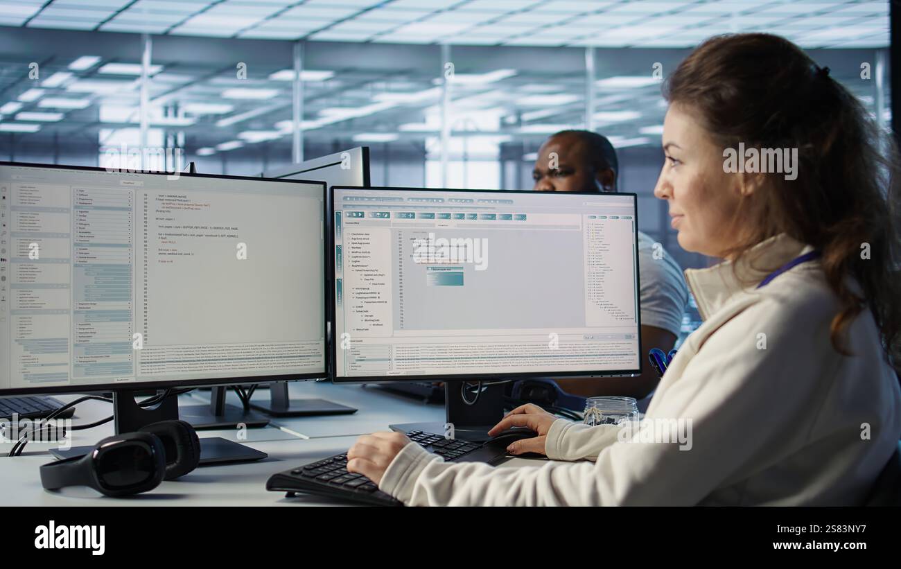 Employee sitting next to african american coworkers in data center ...