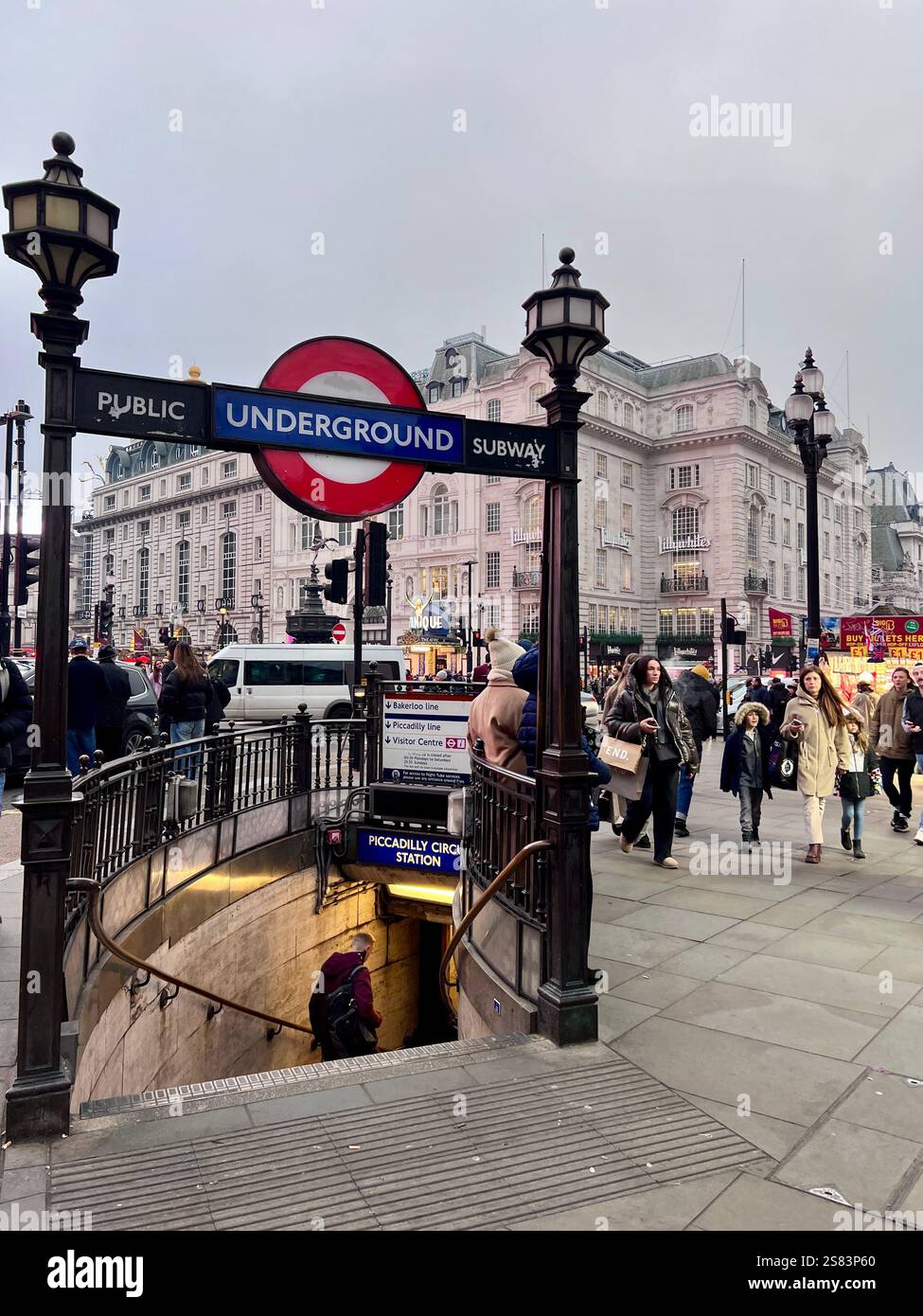 Busy Piccadilly Circus with people walking. Close up of the staircase ...