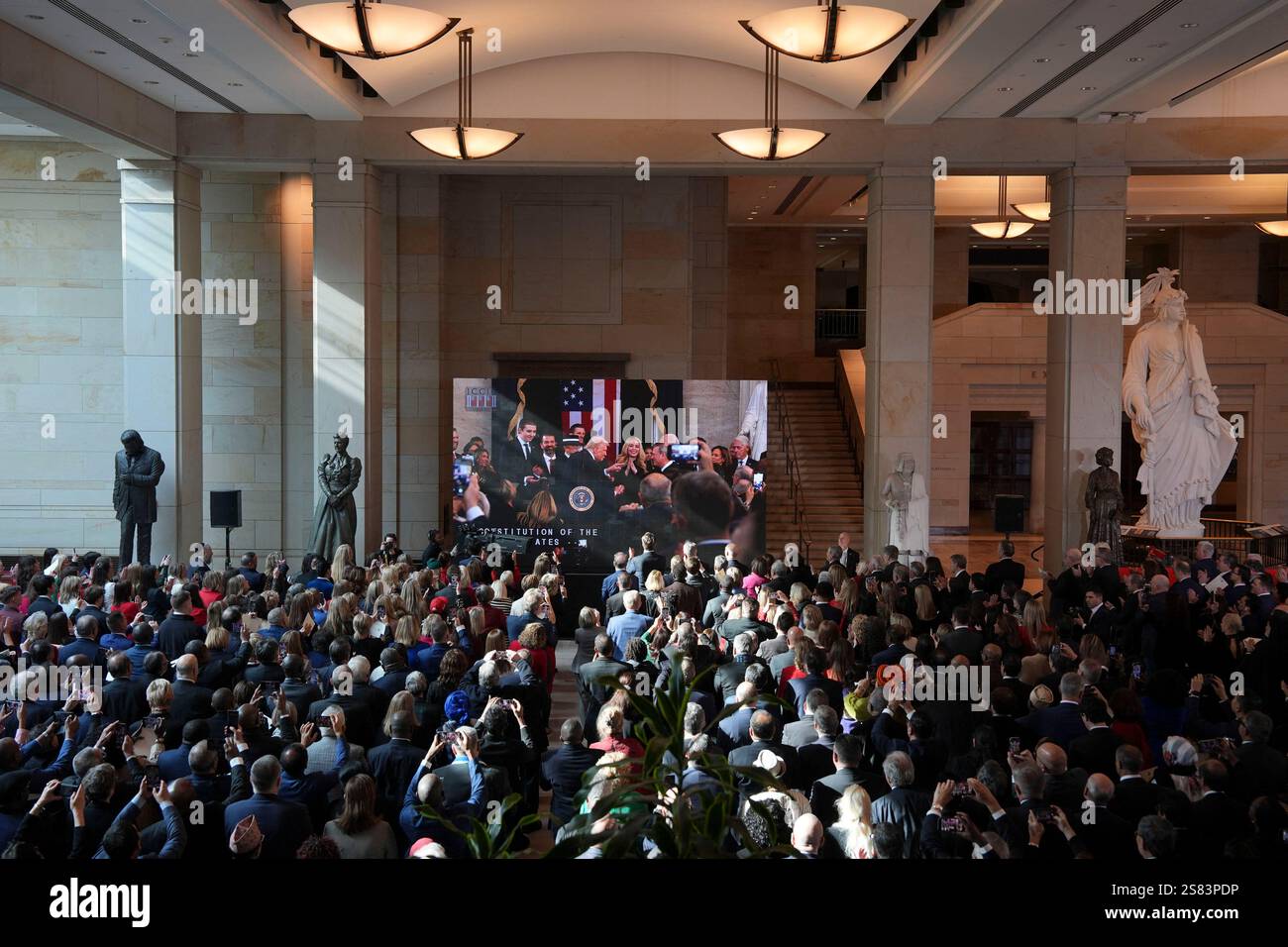 Washington, United States. 20th Jan, 2025. Guests watch as US President ...
