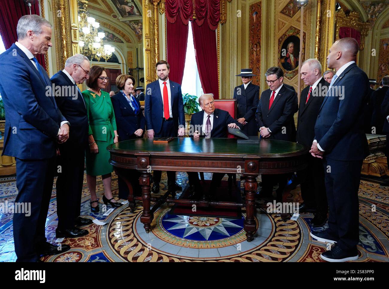 Newly sworn-in President Donald Trump takes part in a signing ceremony ...