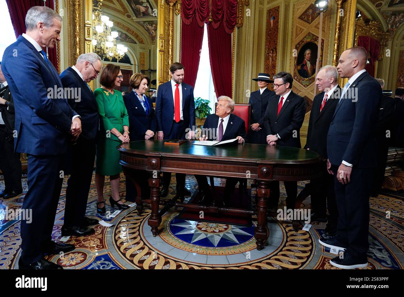 Newly sworn-in President Donald Trump takes part in a signing ceremony ...