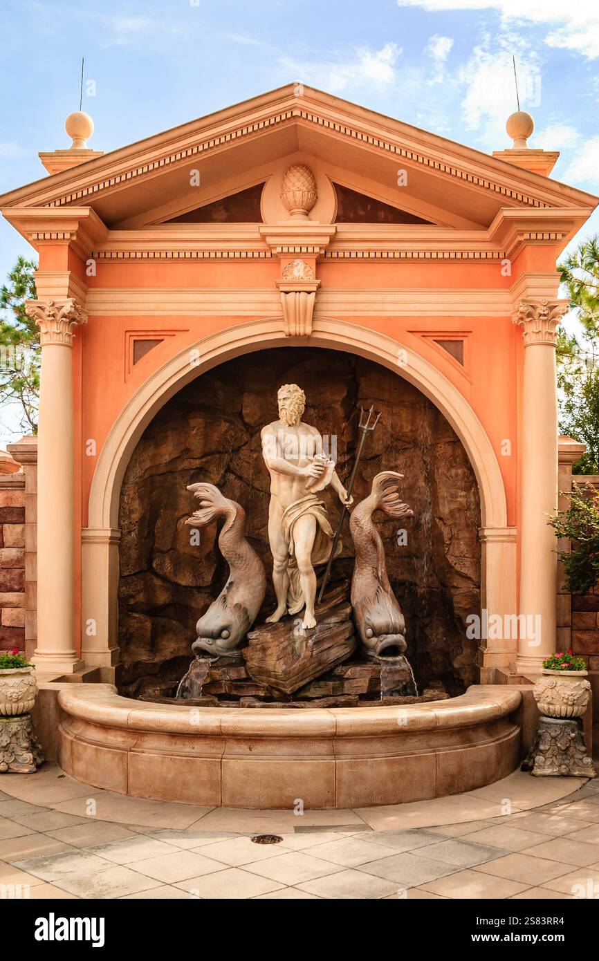 A statue of a man holding a spear and two snakes. The statue is ...