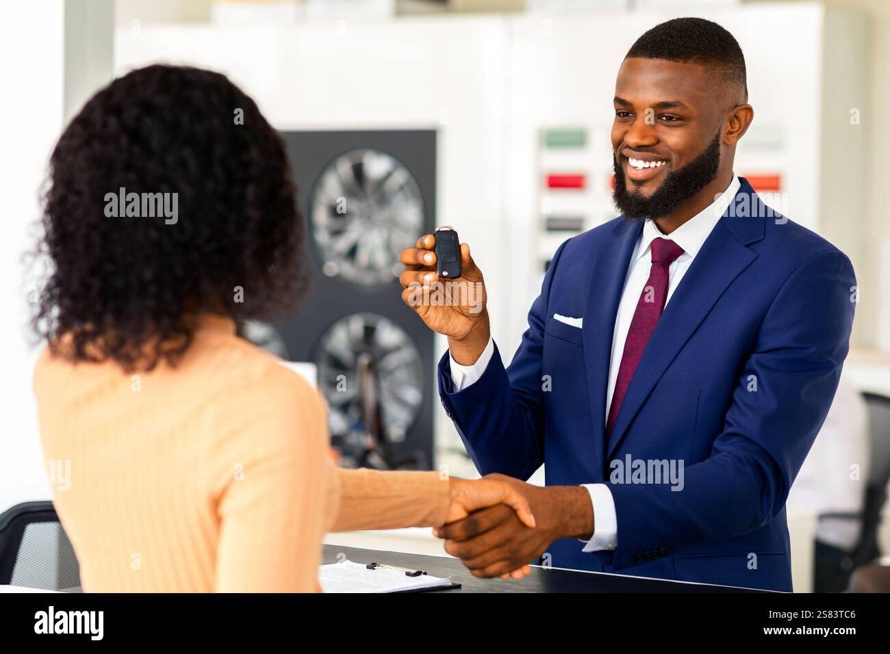 Happy Car Salesman And Female Customer Handshaking After Successful ...
