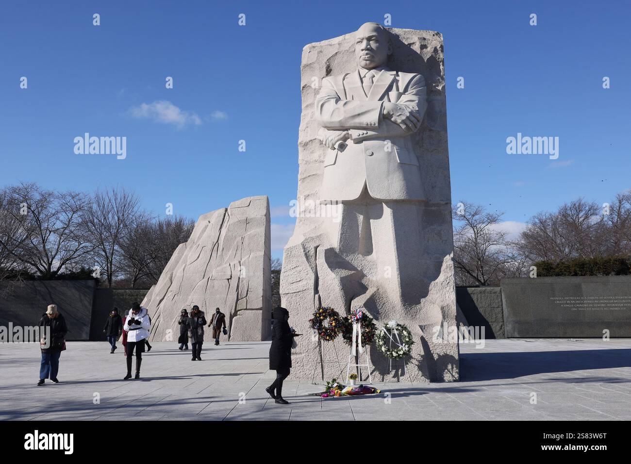 Washington, United States. 20th Jan, 2025. People walk by and pay their ...