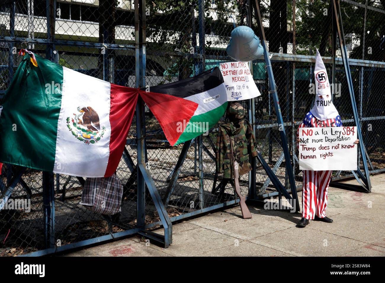 Mexico City, Mexico. 20th Jan, 2025. A person dressed as Ku Klux Klan shows a placard with the ...