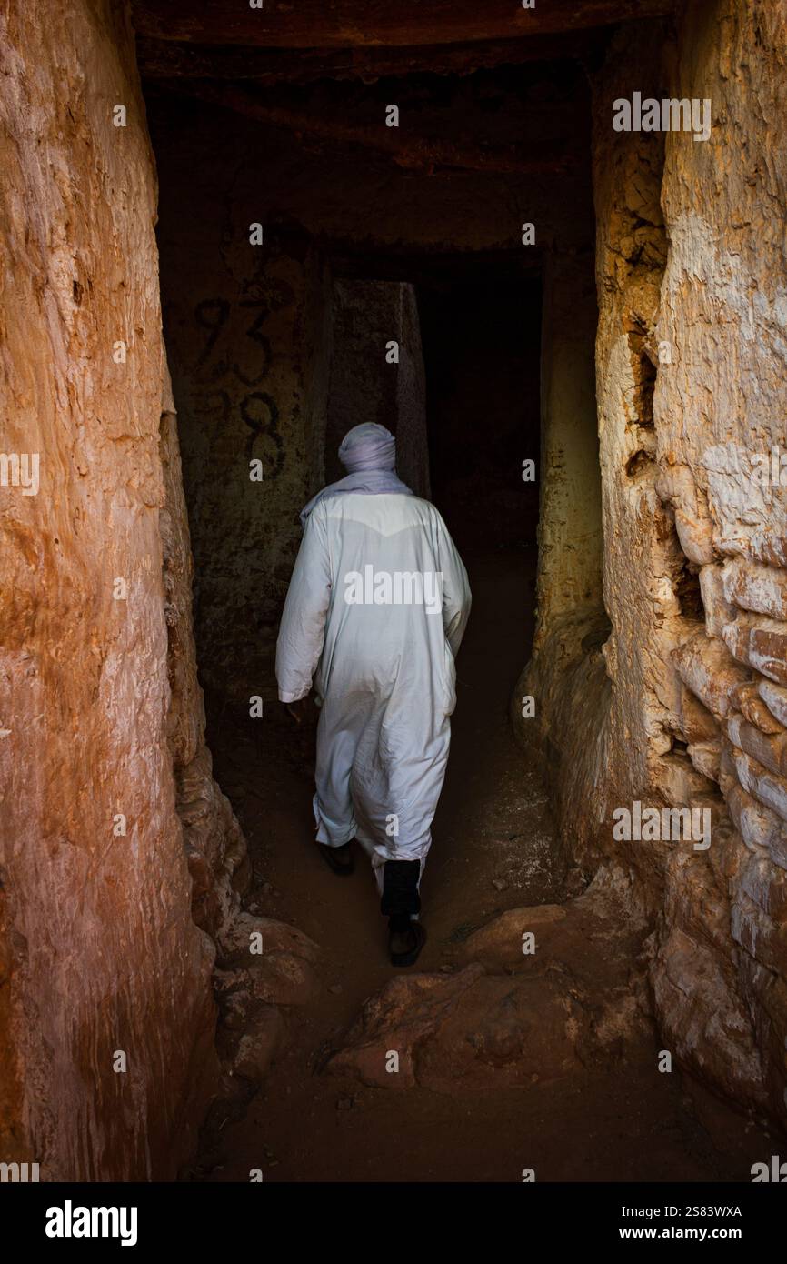 Person in White Robe Walking Through Rocky Passageway Stock Photo - Alamy