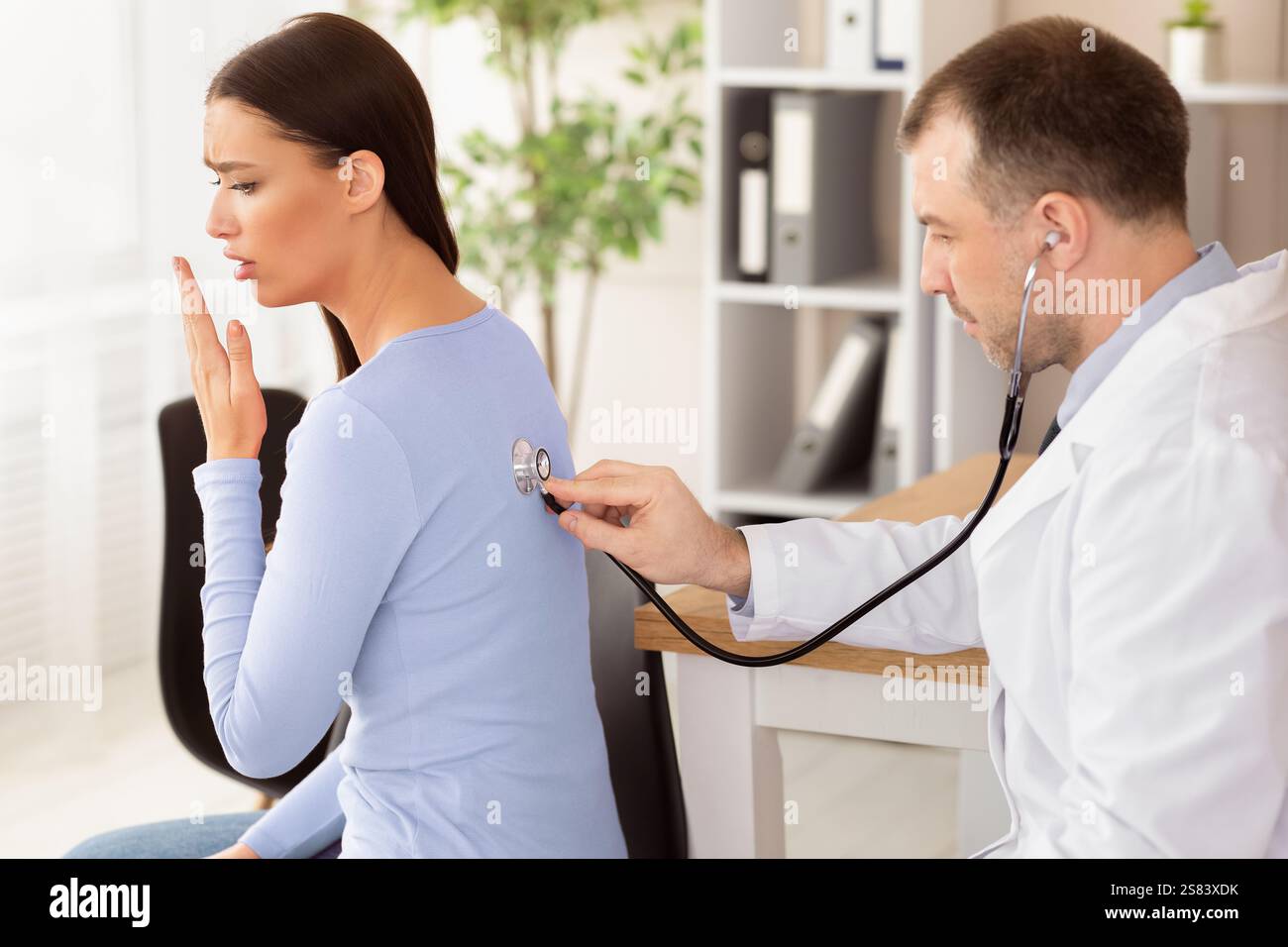 Mature experienced doctor checking breath of female patient Stock Photo ...