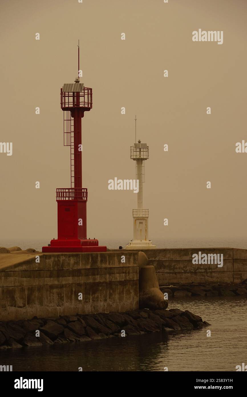The red lighthouse and the white lighthouse in Jeju port Stock Photo ...