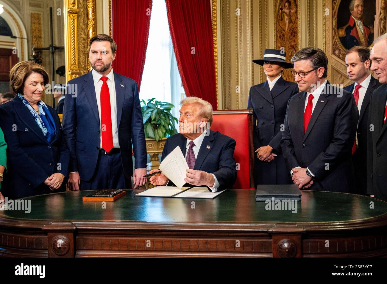 President Donald Trump, center, takes part in a signing ceremony in the ...