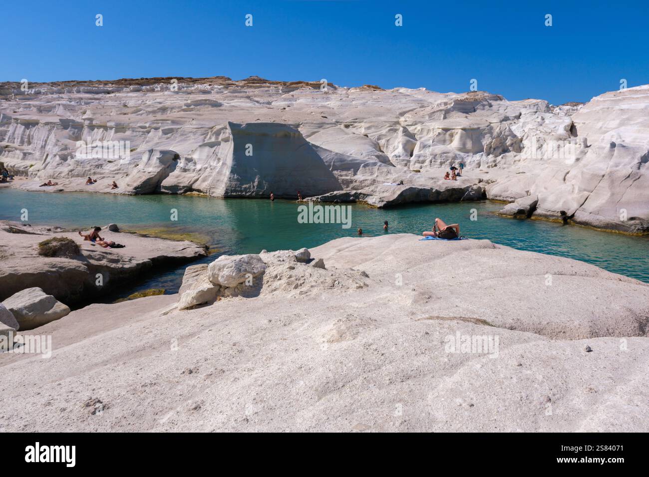 Milos, GR - 28 September 2024: People sunbathing at Sarakiniko beach ...