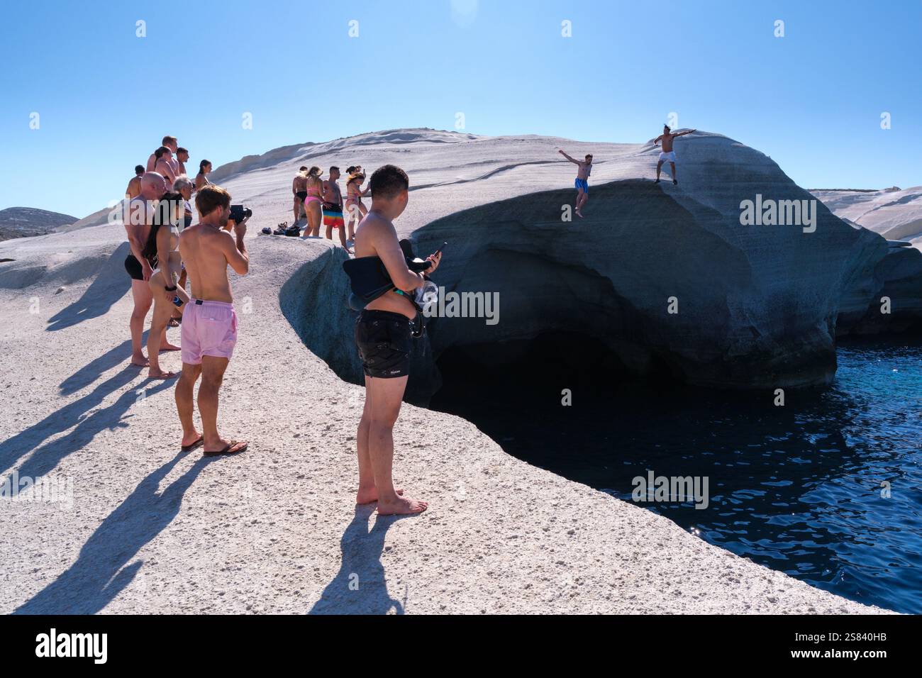 Milos, GR - 28 September 2024: People diving at Sarakiniko beach Stock ...