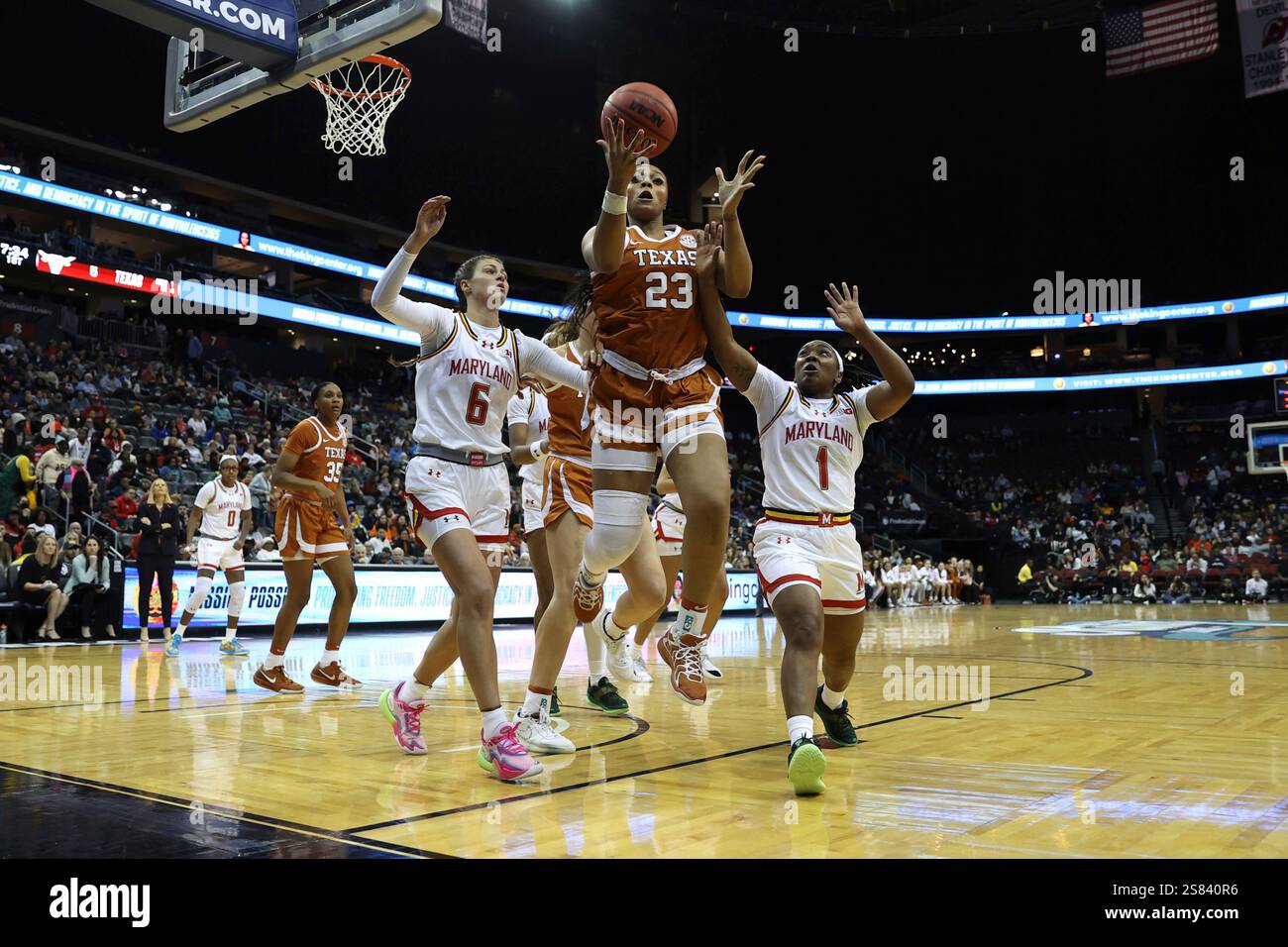 Texas forward Aaliyah Moore, center, defends a rebound from Maryland ...