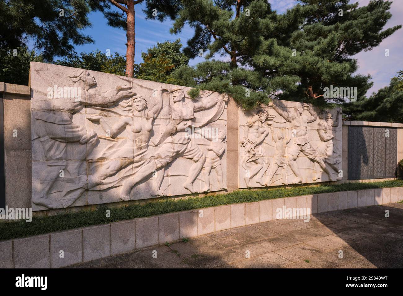 A white marble frieze behind the statue of 'Baekbeom' Kim Gu. In Namsan ...