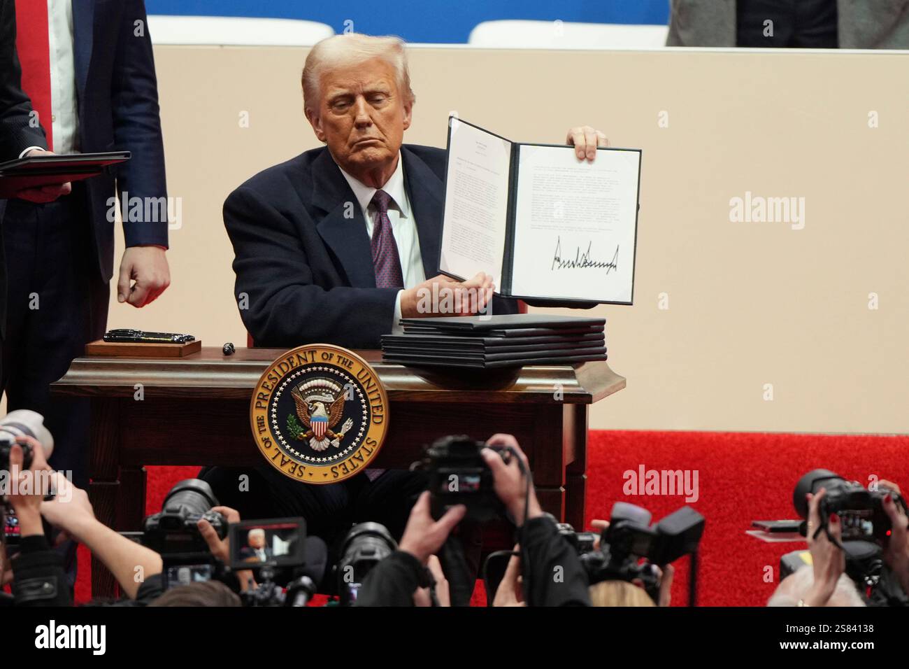 President Donald Trump holds up an executive orders after signing it at ...