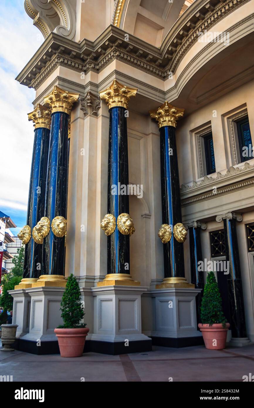 The building has four pillars with gold accents. The pillars are black ...
