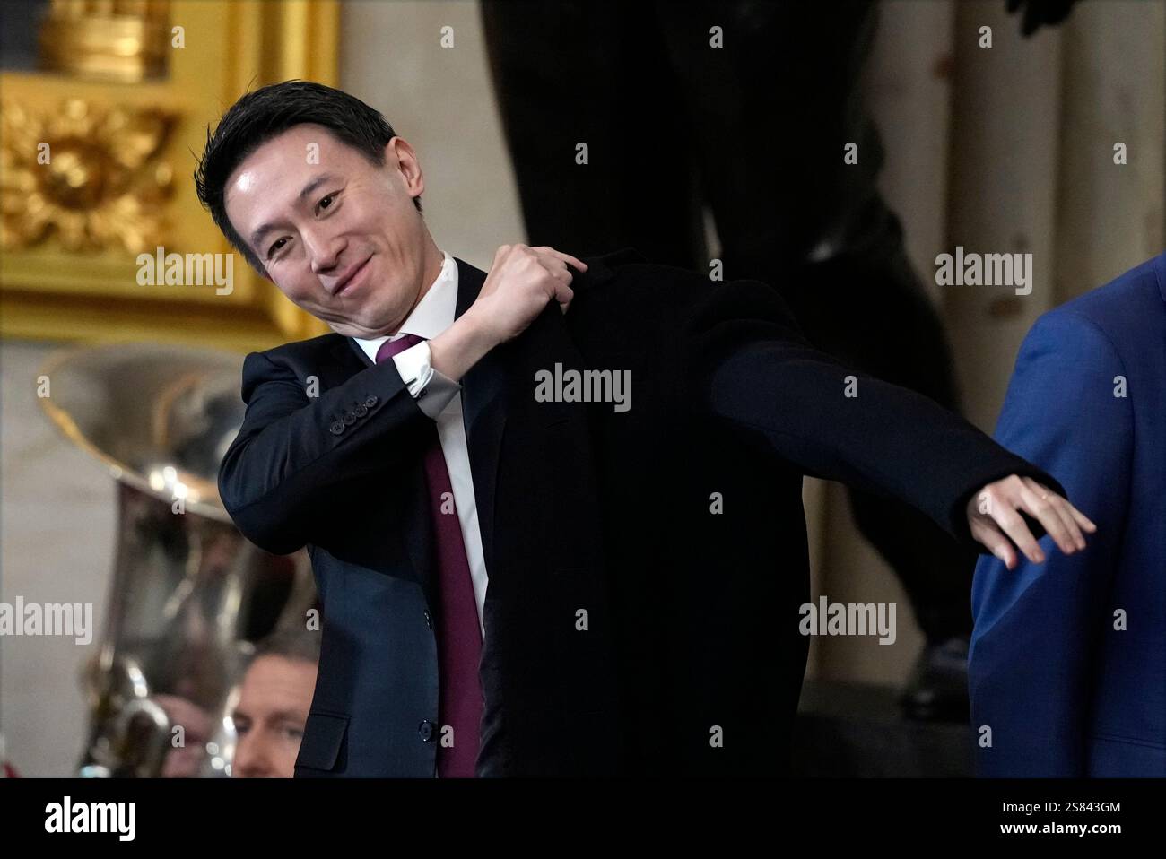 China's Vice President Han Zheng puts on his coat after the 60th ...